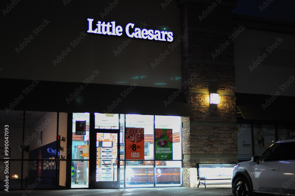 Little Caesars storefront illuminated at night with visible promotional ...