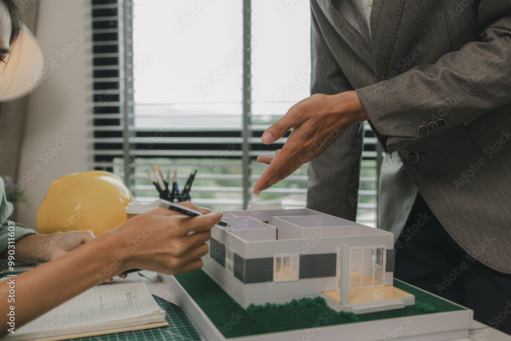 engineer and investor are negotiating the details of a housing project ...