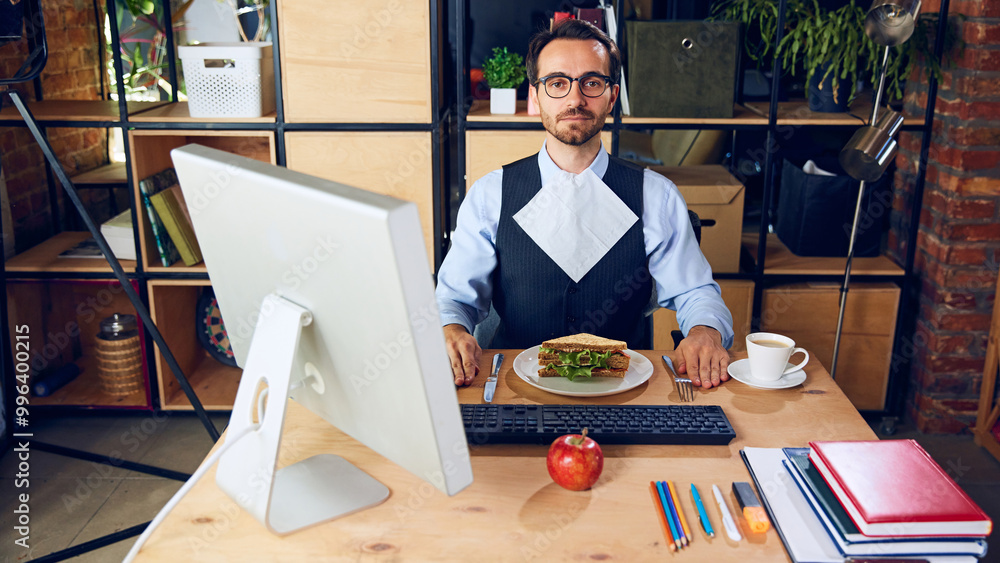 Businessman prepared for lunch at his desk, fully equipped with ...