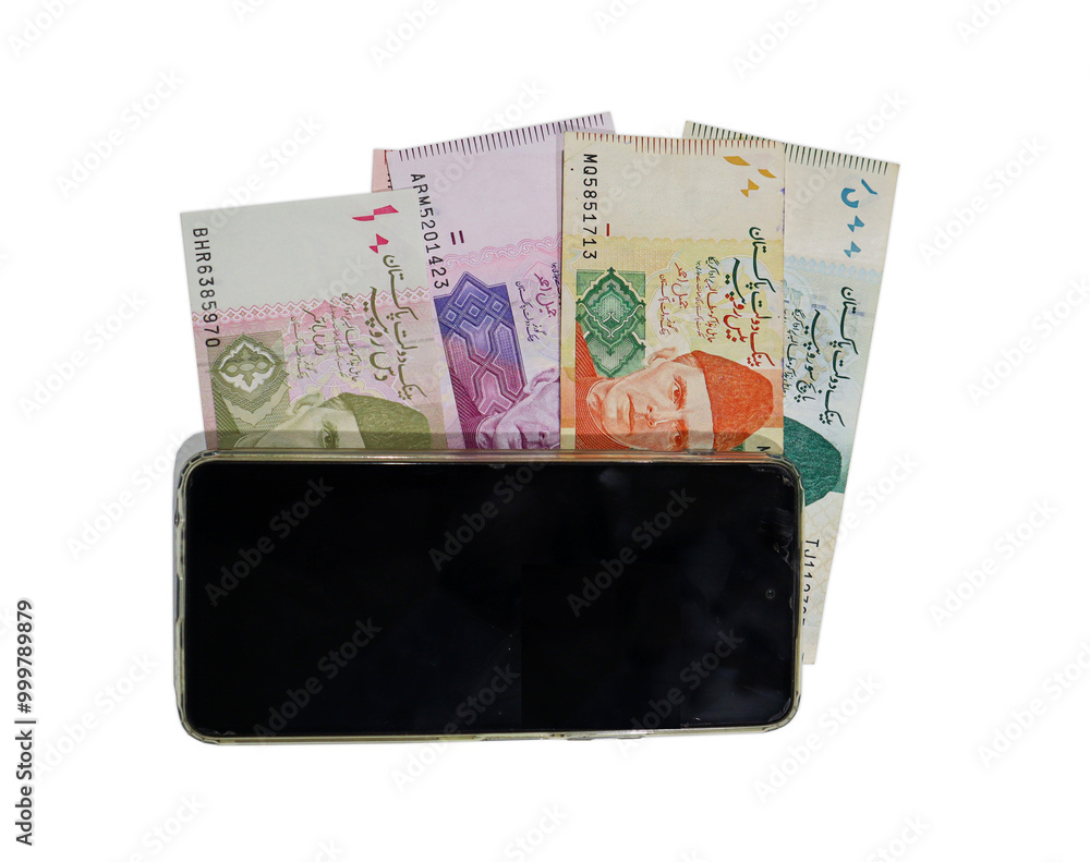 Pakistani currency bank notes aligned under mobile phone horizontally ...
