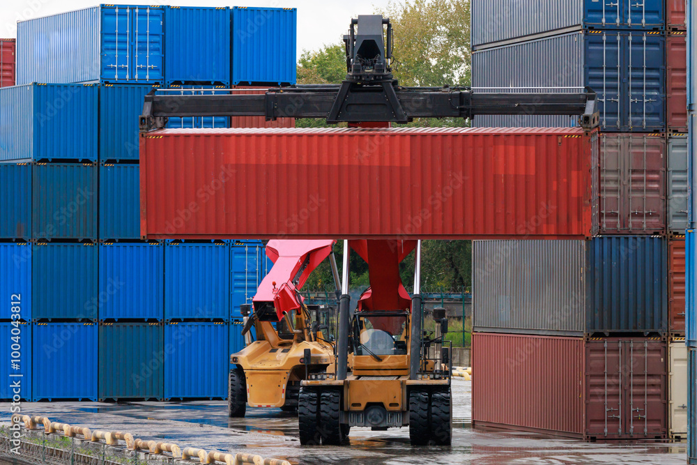 Reach stacker moves intermodal container to railroad platform. Stock ...