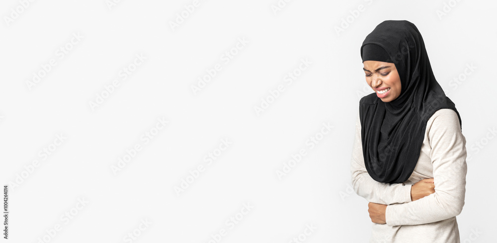Sick black muslim girl in hijab suffering from acute abdominal pain ...