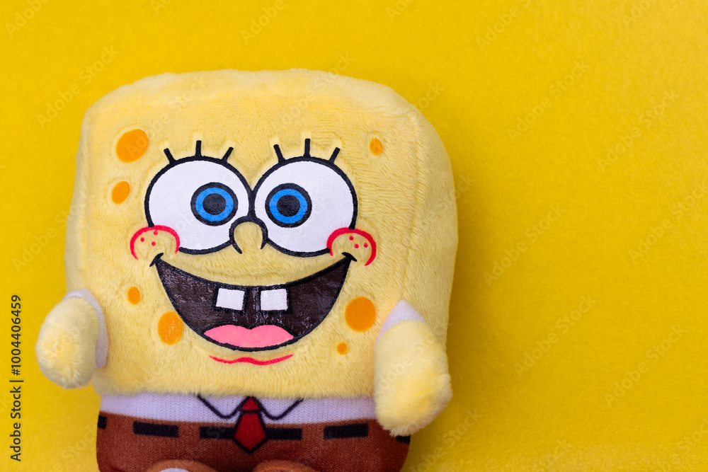 Small plush SpongeBob SquarePants on a yellow background. Funny Sponge ...