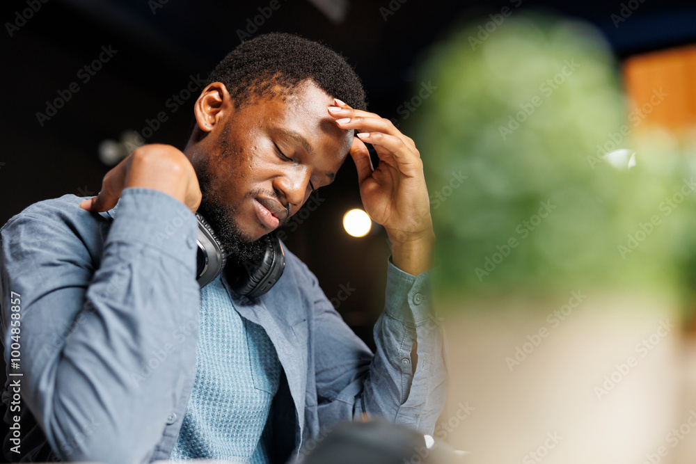 Frustrated african american worker suffers from exhaustion as he works ...