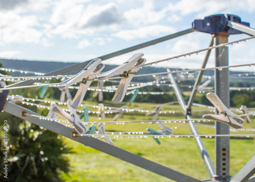 Wet weather concept image with clothes pegs on a washing line dripping ...