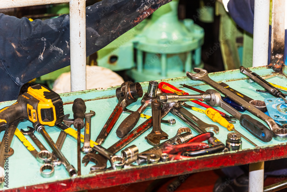A close-up of various tools scattered across a work platform in the ...