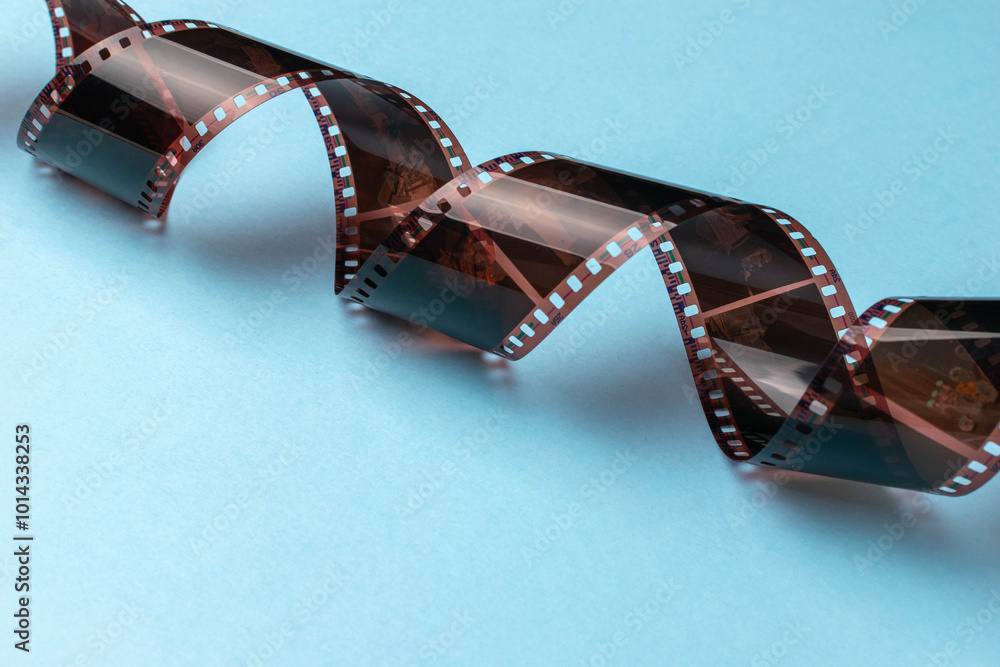 Vintage Film Negative Strip on Light Blue Background Represents Analog ...