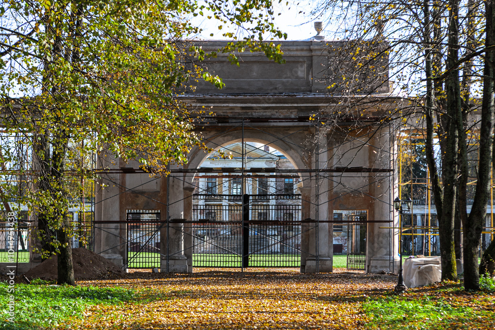 The image shows a neoclassical colonnade under restoration, with ...
