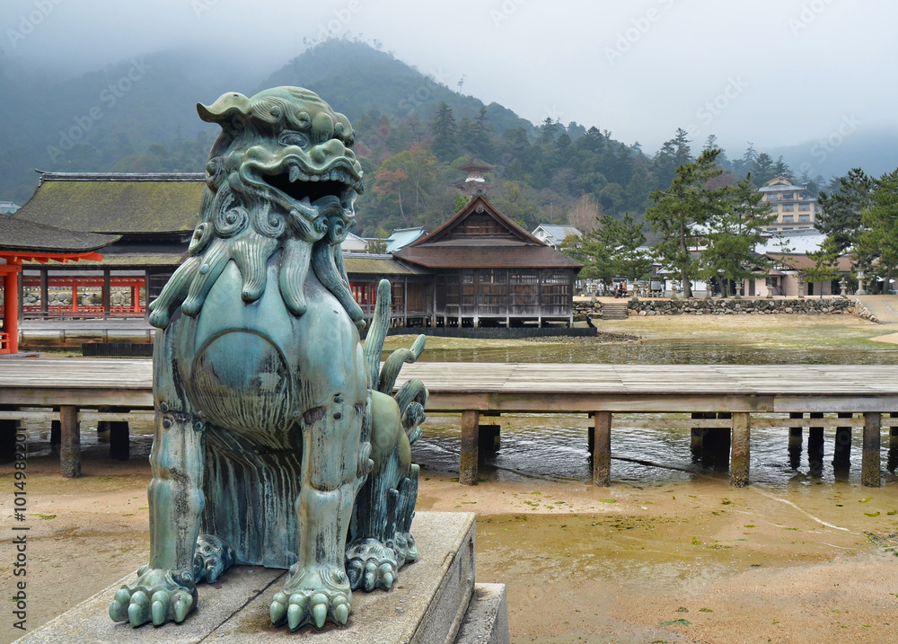 Komainu Lion Dog, guardian statue of Itsukushima Jinja shinto shrine ...