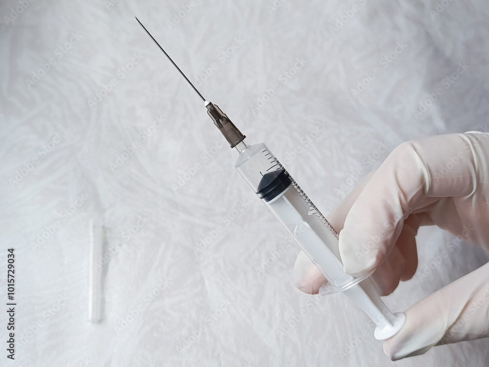 Open syringe on white background. Hand in medical glove holds syringe ...