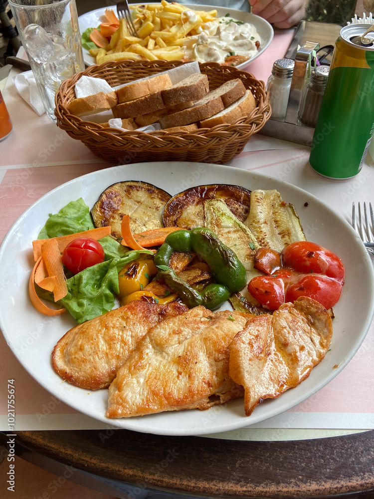 Delicious meal featuring grilled vegetables and chicken breast is ...