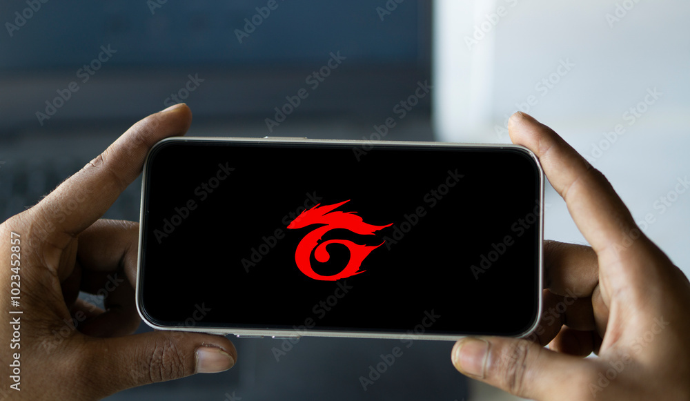 Dhaka, Bangladesh- 10 Oct 2024: Garena logo is displayed on smartphone ...