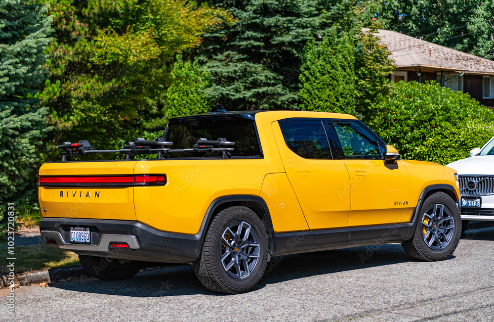 Rivian R1t SUV electric yellow car view from the front and passenger ...