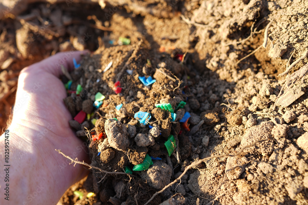 Microplastic pollution. Microplastics in ground. Soil contaminated with ...
