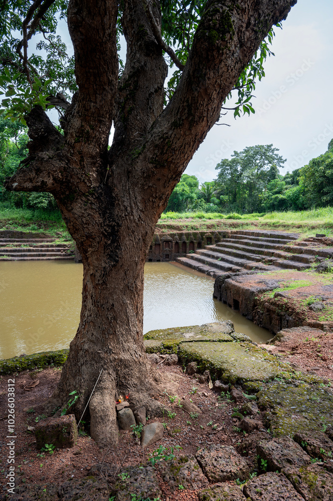 Narrow stone pathway beside ancient walls at Saptakoteshwar Temple on ...