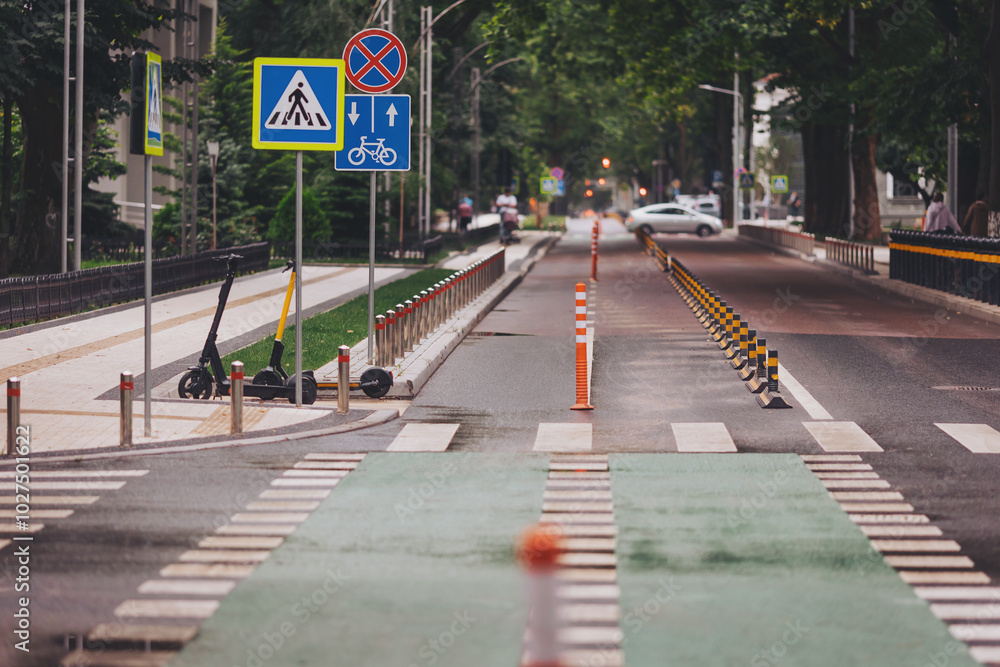 City street with many trees. new traffic safety speed bump on an ...