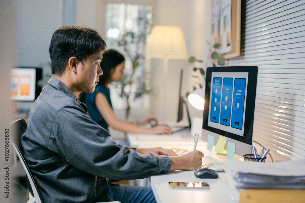 Two Asian Ui Ux Designers Are Working Together In The Office Developing The User Interface Of A