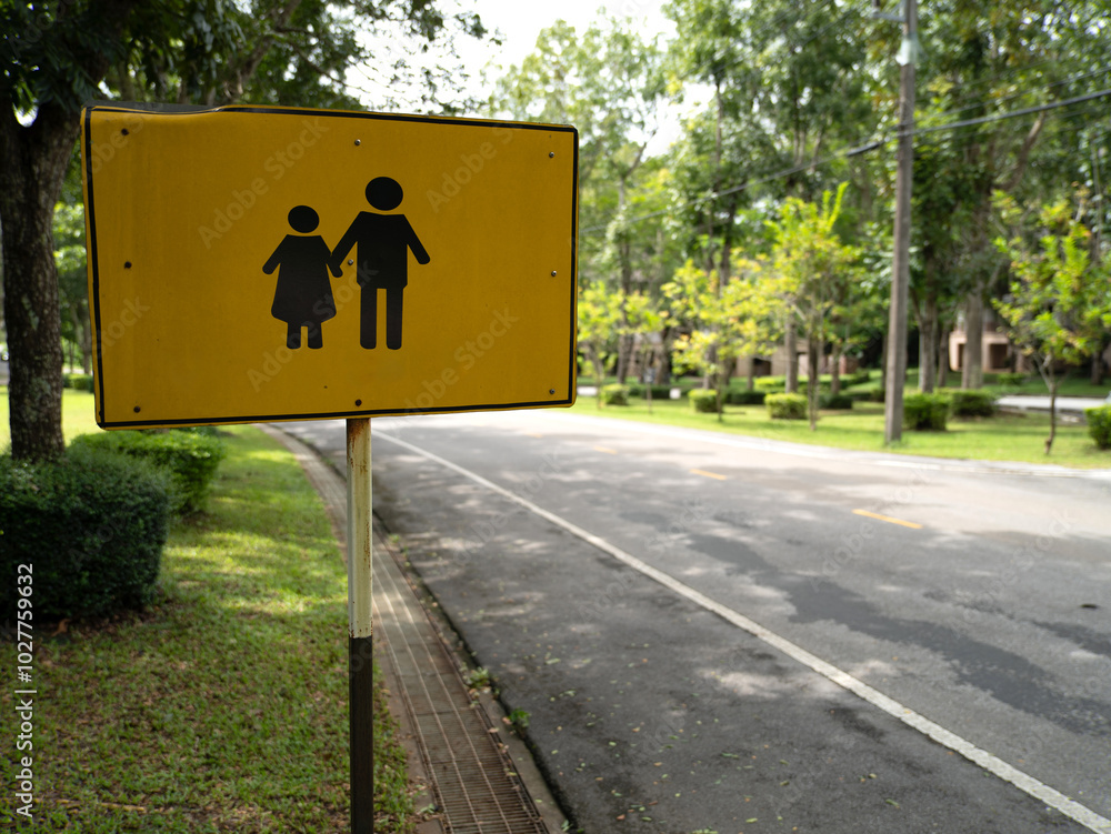 Yellow pedestrian crossing warning sign in a school , child zone ...