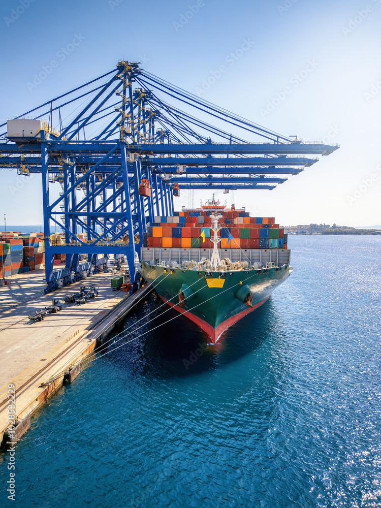 Front view of a large container cargo vessel beeing loaded and unloaded ...