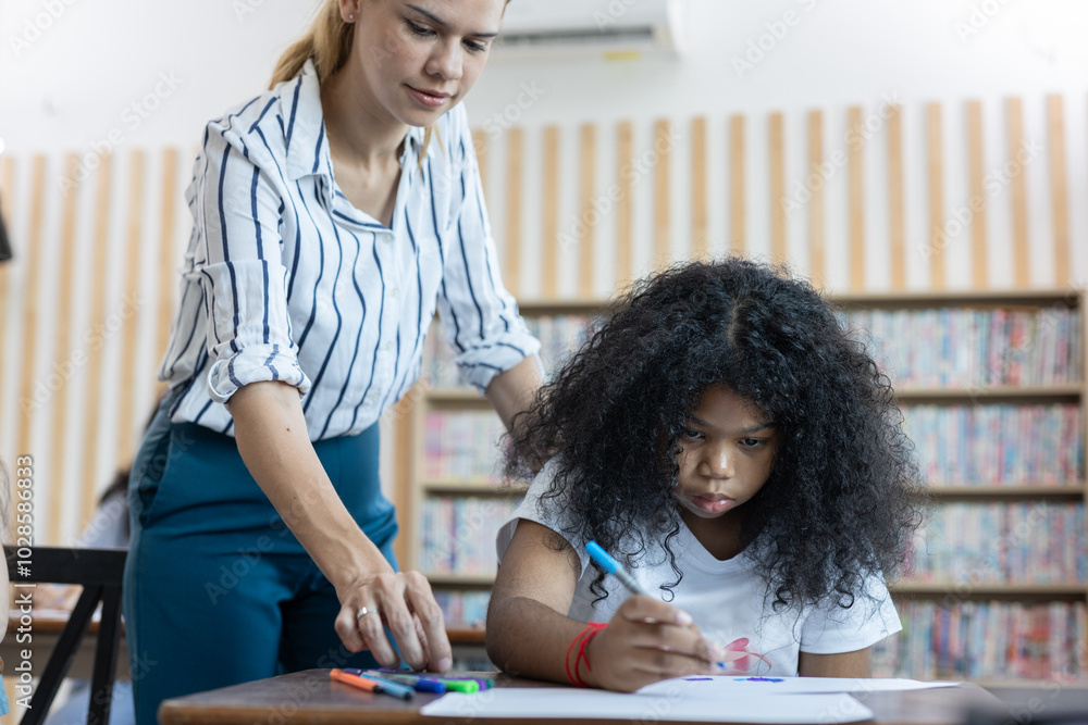 female teacher is teaching girls in class. School children education in ...