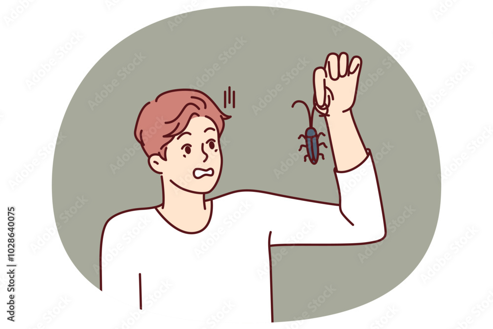 Man with bug in hand, looks at insect and gets scared suffering from ...