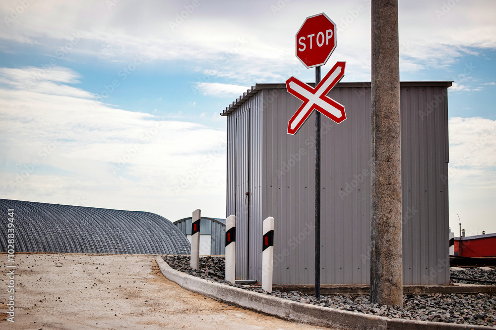 Railroad crossing featuring a stop sign, barrier, and safety shed ...