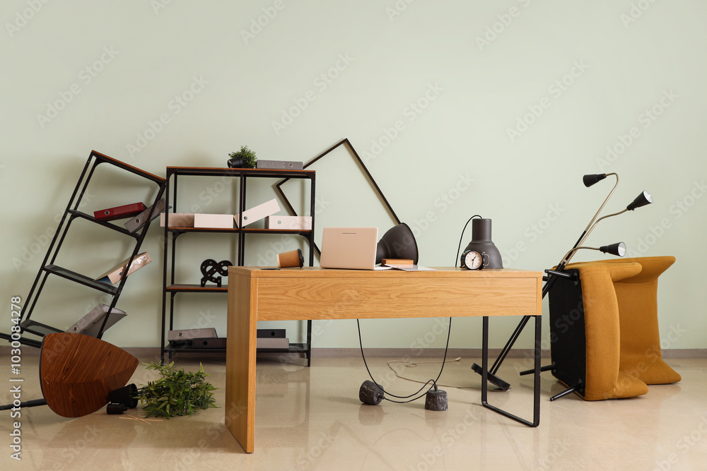 Interior Of Messy Office With Wooden Desk And Overturned Shelving Units