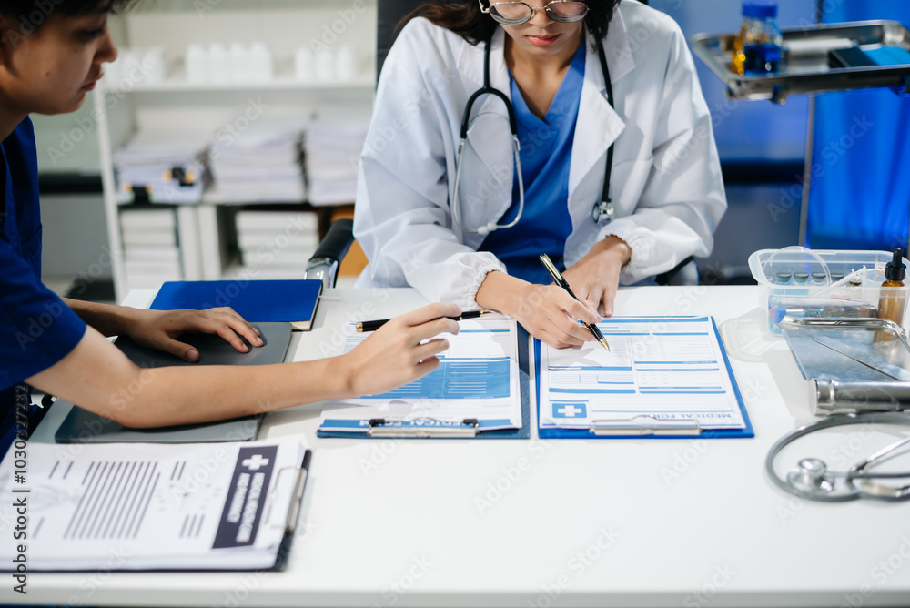 Doctors and nurses review medical paperwork and prescriptions in a ...