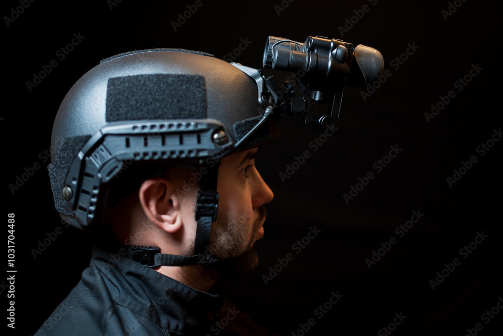 Military man in tactical helmet with night vision device on black ...