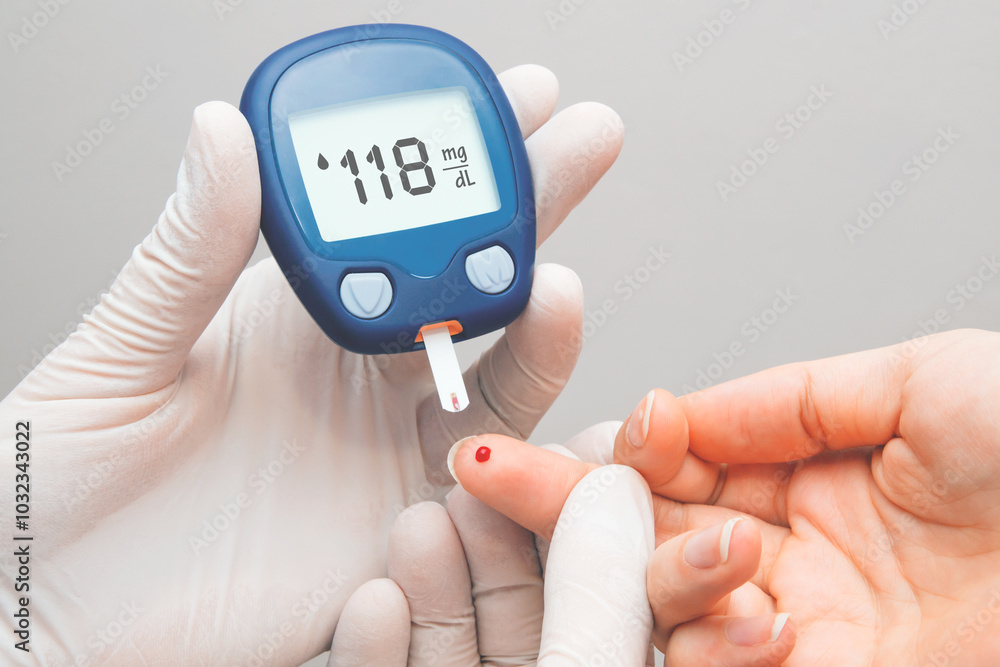 Person is taking their blood sugar reading Stock Photo | Adobe Stock