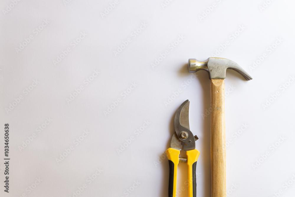Metal hammer with wood handle and pruning scissors or garden trimmer ...