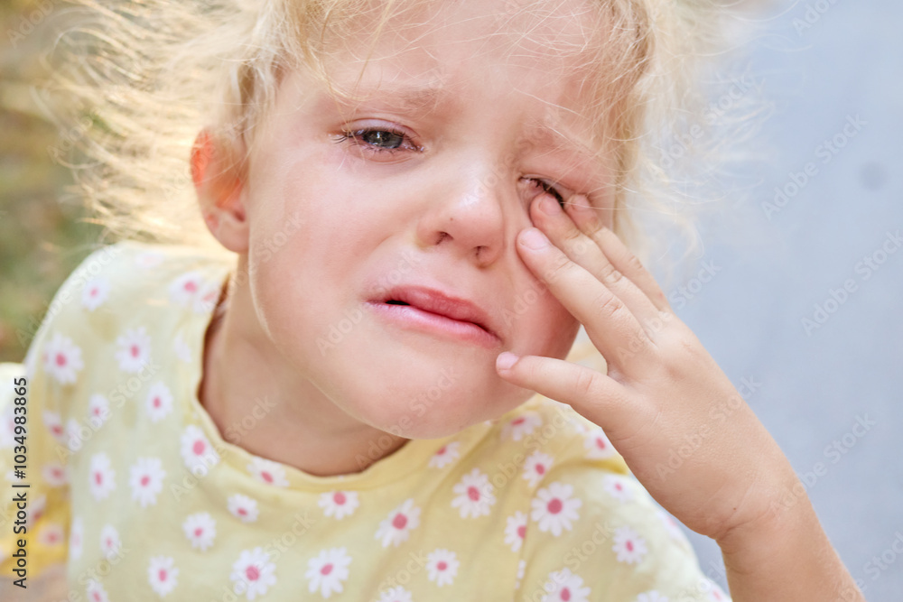 Blonde child girl crying with tears rolling down her cheeks showing ...