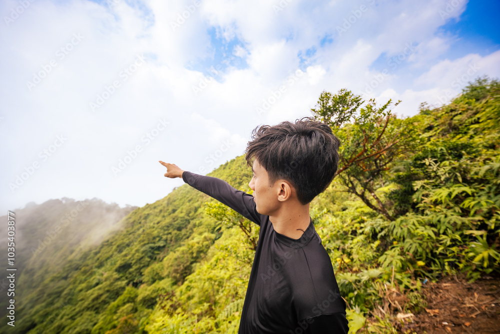 Solo Traveler Pointing to Nature at the Mountain Summit, Embracing the ...