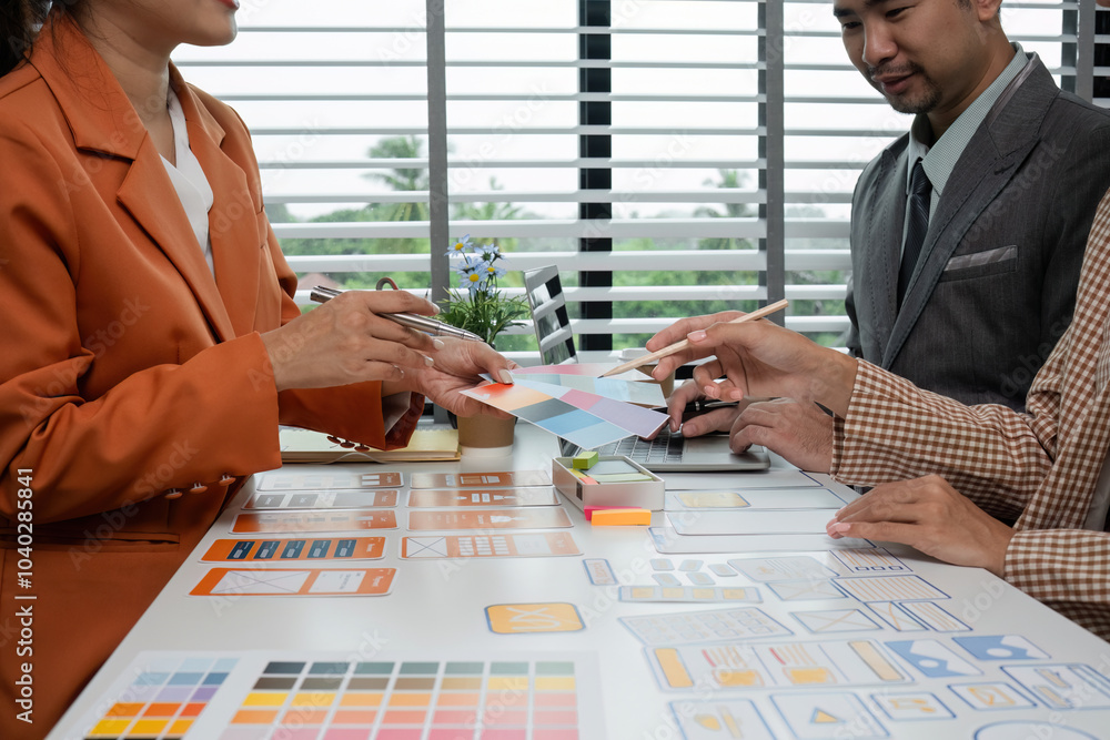 Creative Team Collaborating On Ux Ui Design Concepts With Color Swatches And Wireframes In