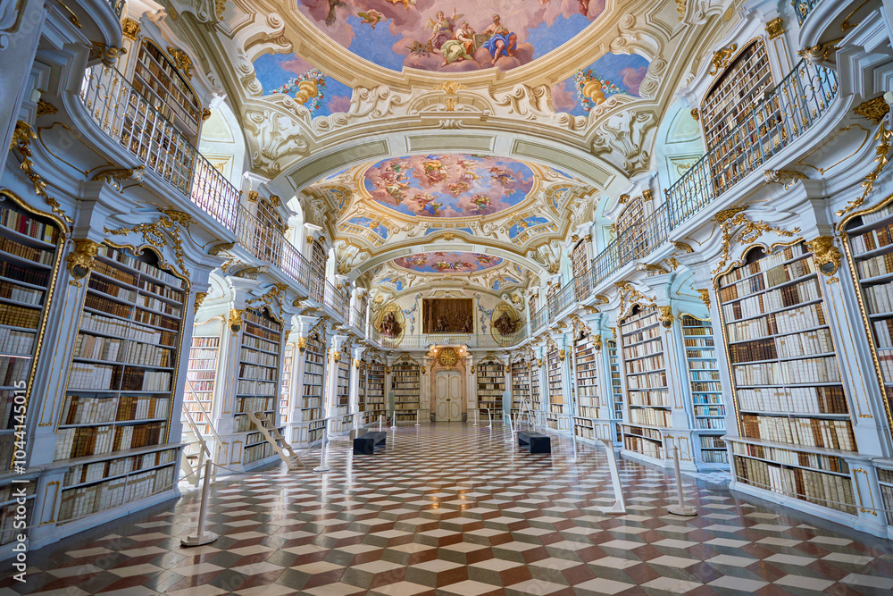 Admont library, Austria, 25 July 2024. A grand baroque library with ornate bookshelves filled ...