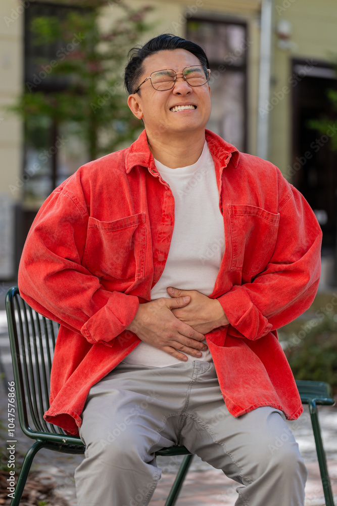 Asian middle-aged man feeling sudden strong abdominal stomach ache ...