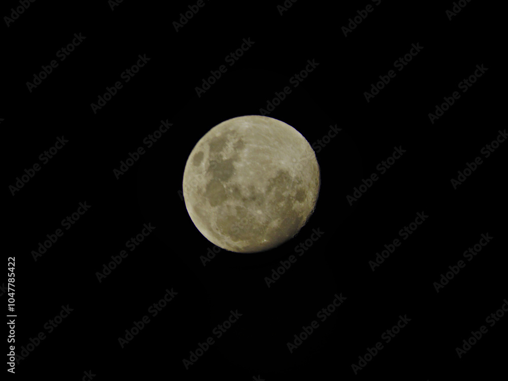 Gibbous Moon (waxing to full moon), floating under the night sky in the ...