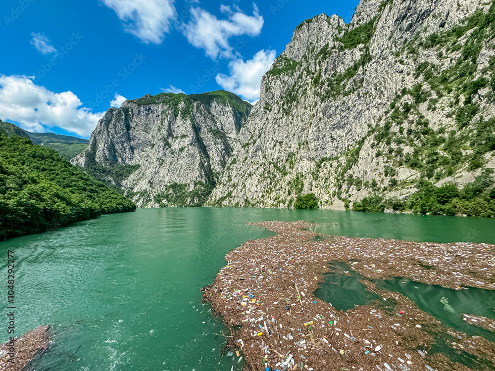 Heavily polluted, with large patches of debris and trash floating on ...