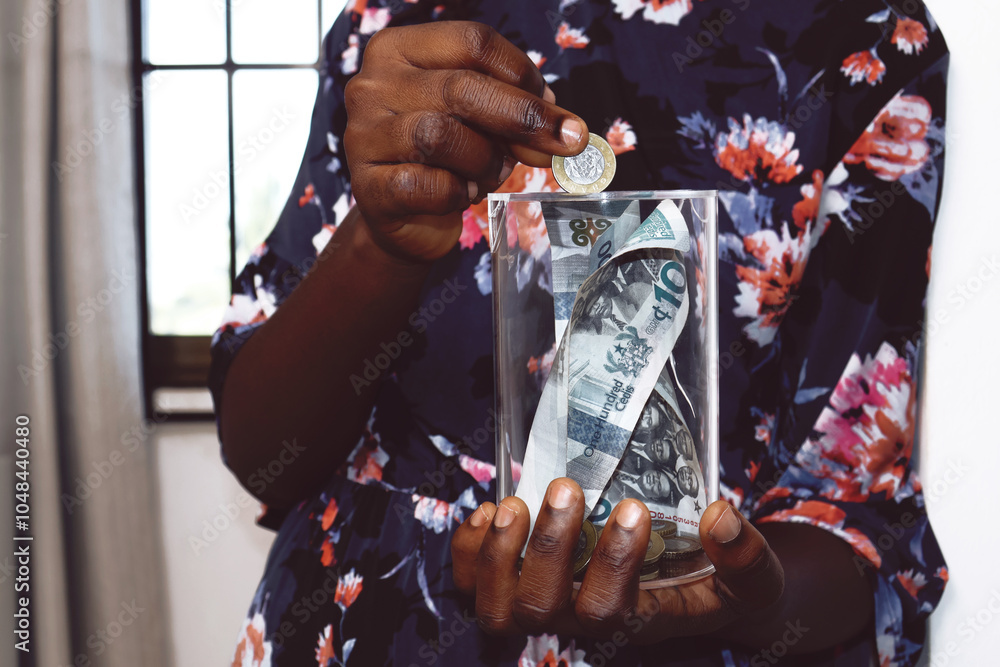 Young black african woman lady girl putting ghanaian cedi coin into ...