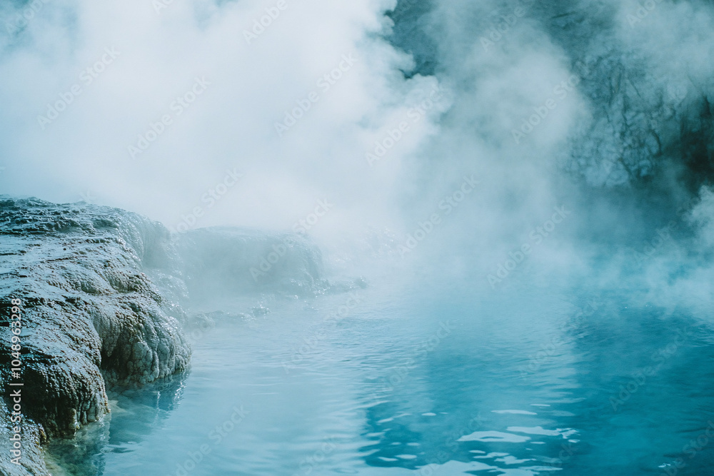 mystical blue hot springs lake with white steam and foggy atmosphere in ...