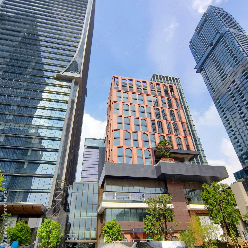 Modern residential and office buildings soar into blue sky at mixed-use ...