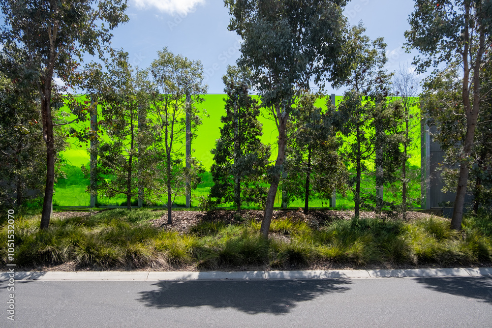 Transparent modern green noise wall by a highway with native vegetation ...