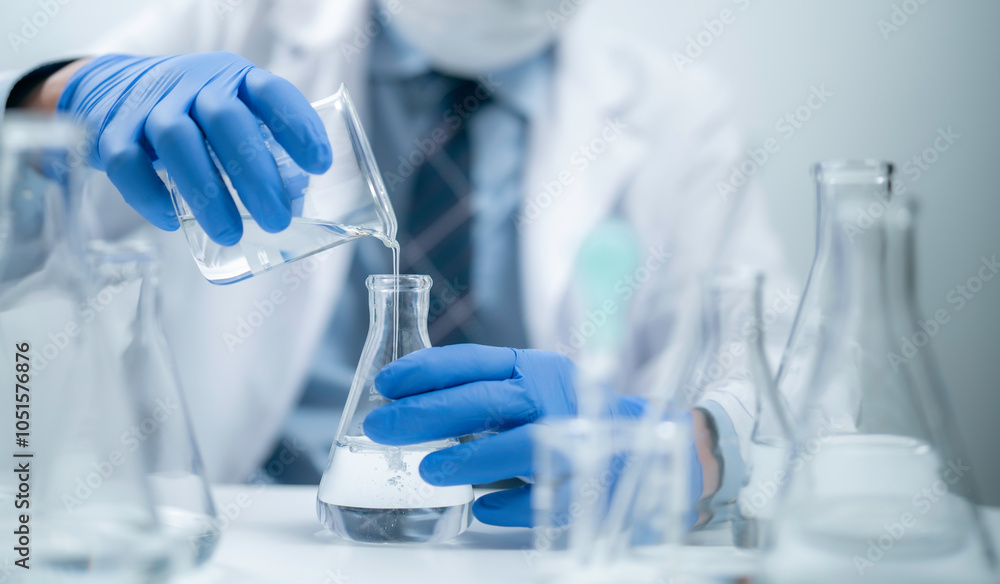 Hands holding pouring fluid liquid beaker flask test tube glassware ...