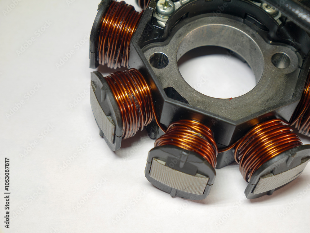 a motorcycle stator, featuring copper windings around iron cores ...