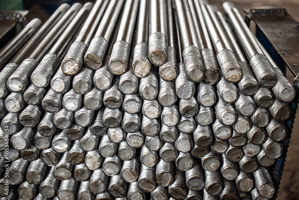 Metal blanks and products stacked in an industrial workshop showcasing ...