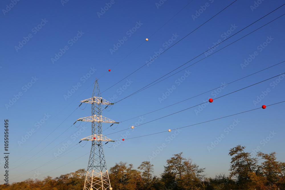 The colored plastic balls hanging on overhead electricity wires are ...