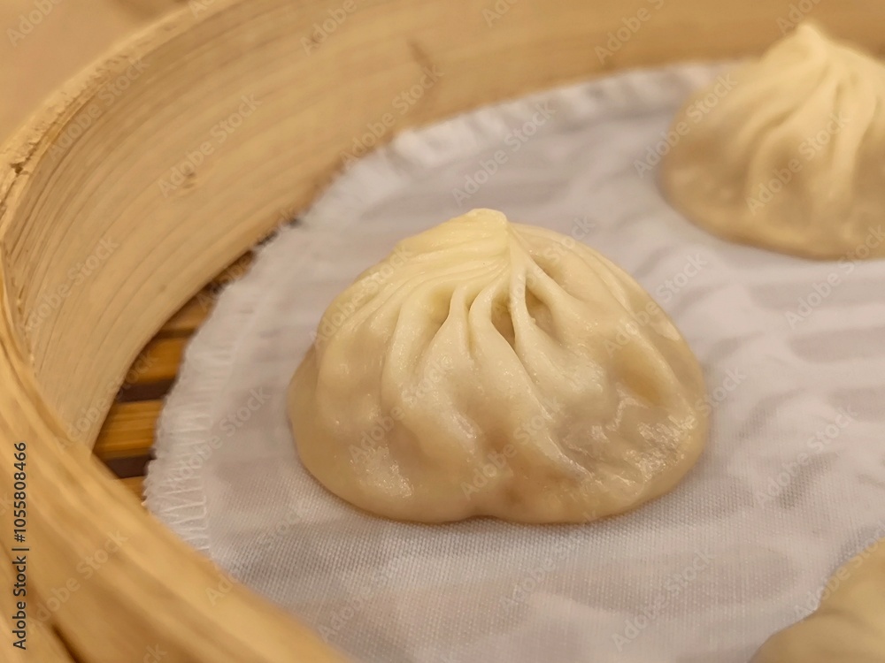 Xiao long bao in bamboo steaming basket. Steamed pork soup dumpling ...