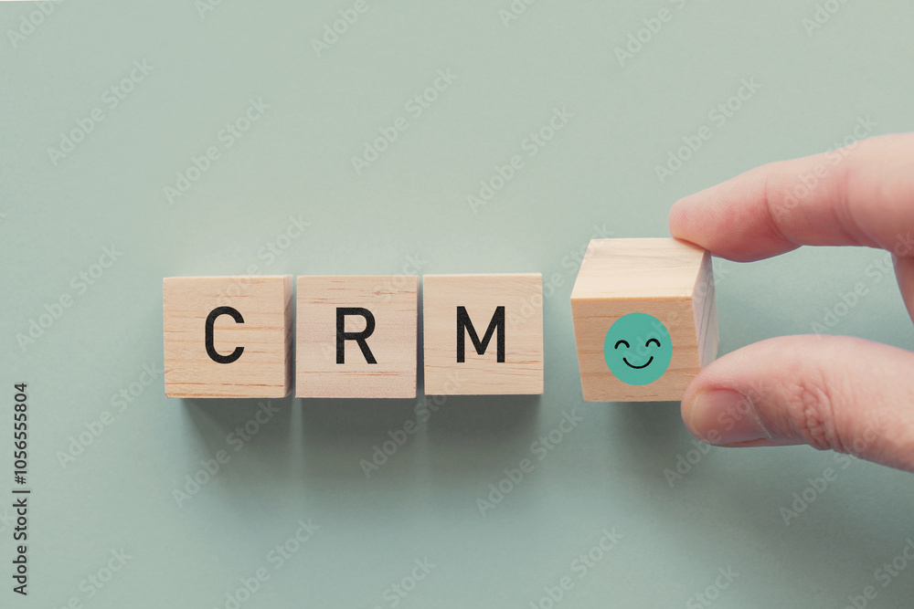 Hand holding wooden block with CRM and happy face icon, good customer ...