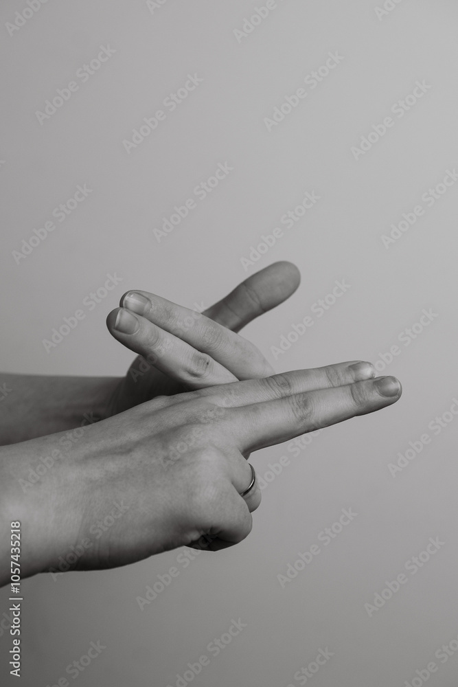 Two human hands making delicate and expressive gestures against a plain ...