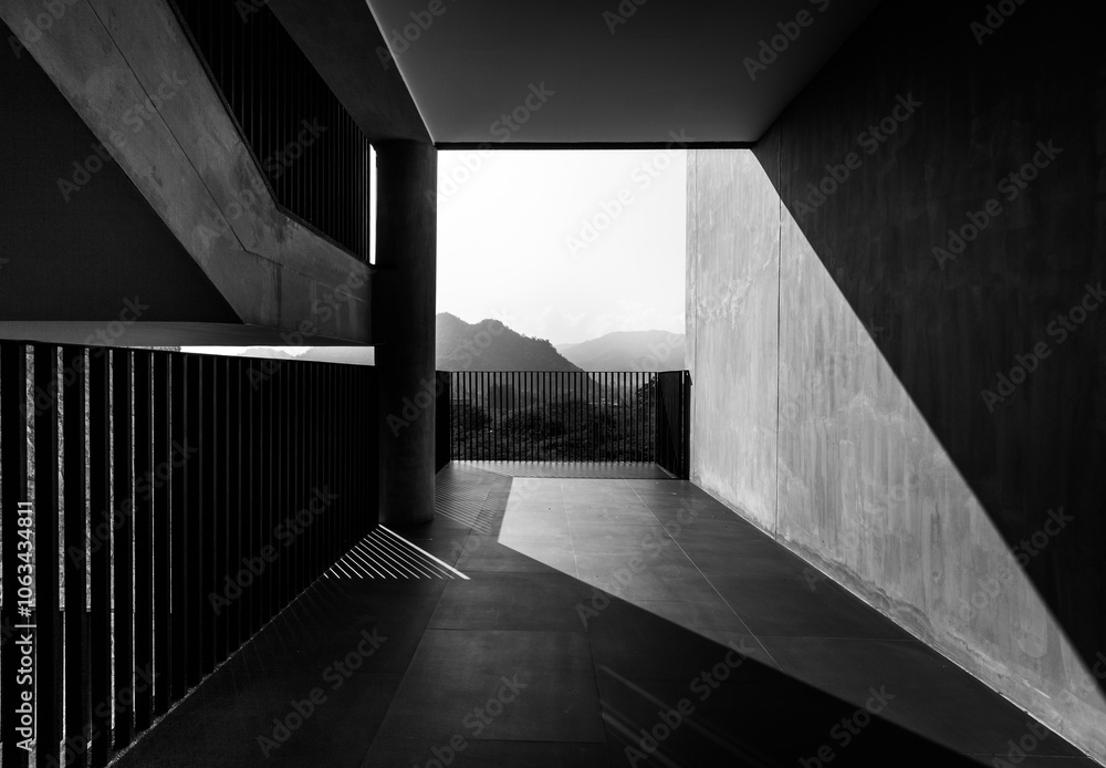 Architecture details of concrete staircase with walkway and mountain background, in black and ...